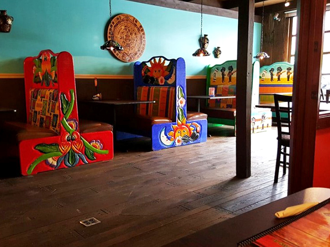 These vibrant booth seats aren't just furniture—they're art pieces telling stories of Mexico while supporting your quest for the perfect taco.