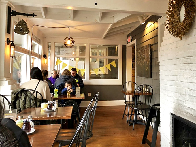 A dining area where sunshine streams through windows, yellow bunting adds cheer, and conversations flow as easily as the coffee refills.