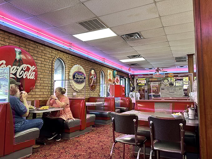 Red booths against exposed brick walls create the perfect setting for conversations that flow as freely as the coffee refills.