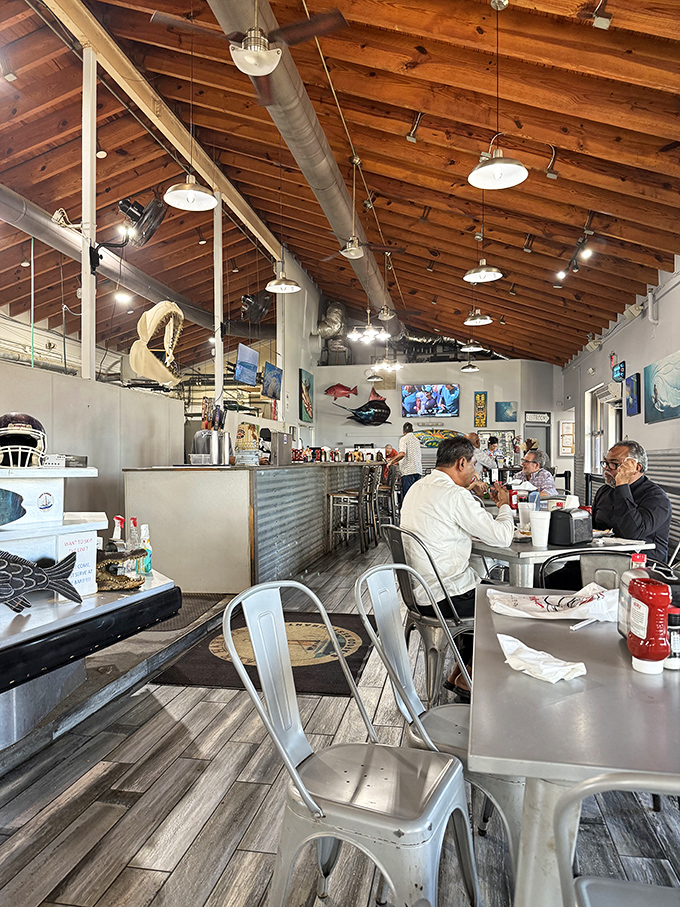 Industrial-chic meets maritime charm. The wooden ceiling beams and nautical decor create the perfect backdrop for seafood feasting.