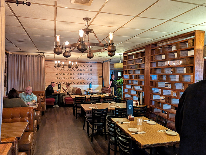 Warm wood tones, rustic chandeliers, and thoughtful spacing make this dining room feel like the great room in a luxury ranch house.