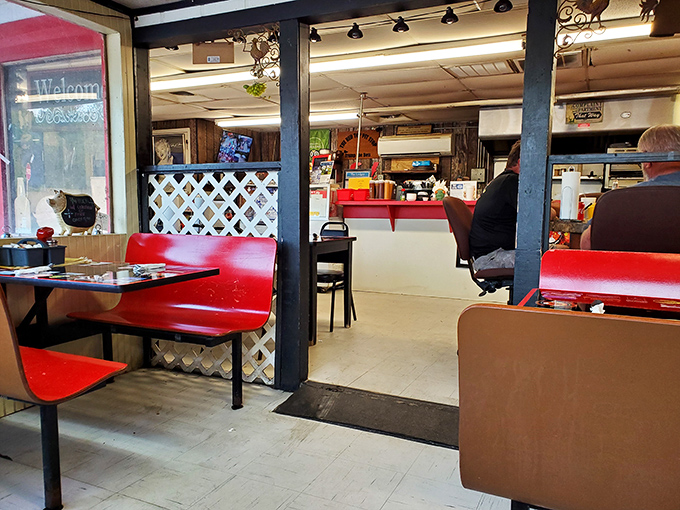 Red booths separated by lattice dividers create the perfect balance of privacy and community&mdash;like Facebook before it went digital.