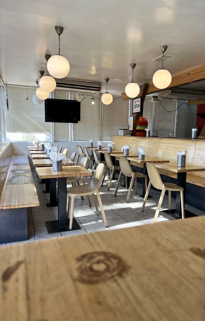 Modern meets retro in this dining area where globe lights hover like friendly planets above wooden tables that have witnessed countless food epiphanies.