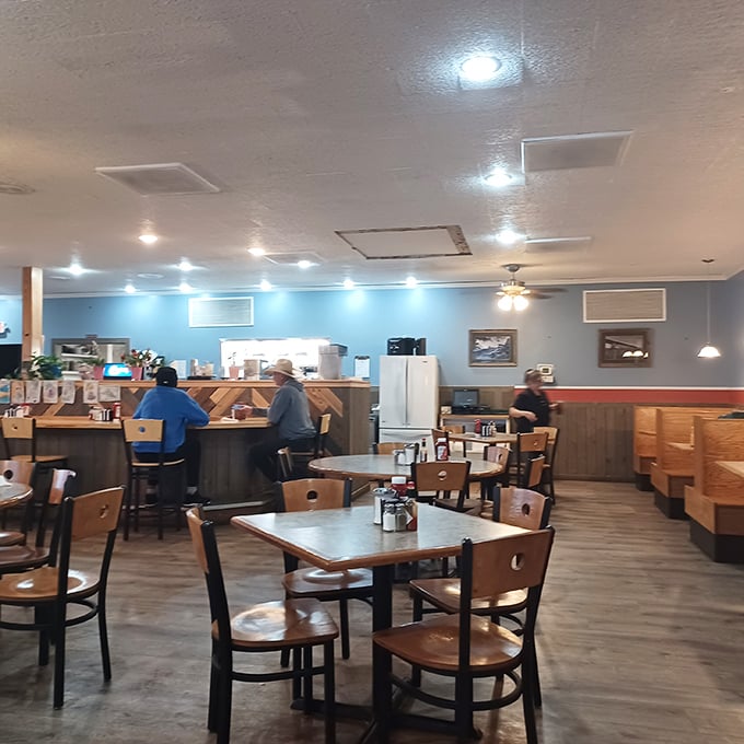 Wooden chairs, warm lighting, and walls adorned with local wisdom. The kind of dining room that makes fast food feel like the sad option it is.