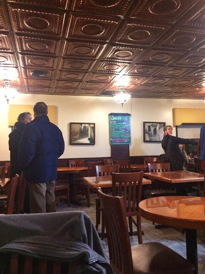 The dining room's ornate tin ceiling and warm lighting create that rare atmosphere where both first dates and family reunions feel equally at home.