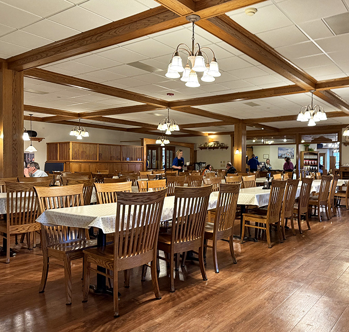 Wooden chairs and warm lighting create a dining space that says, "Stay awhile, have another slice of pie, tomorrow's diet can wait."