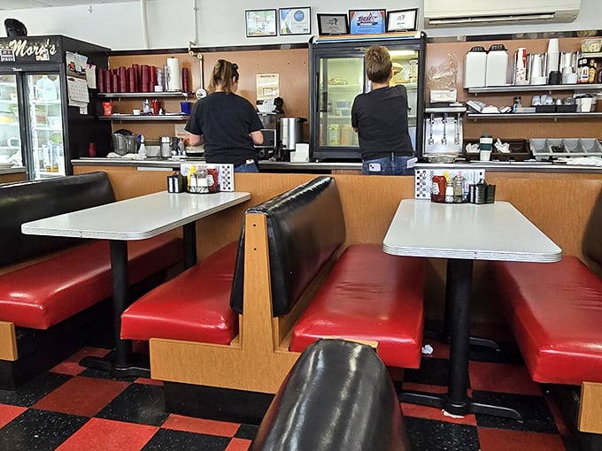 Classic diner booths where countless life decisions have been made over hashbrowns and where the vinyl remembers every customer's story.