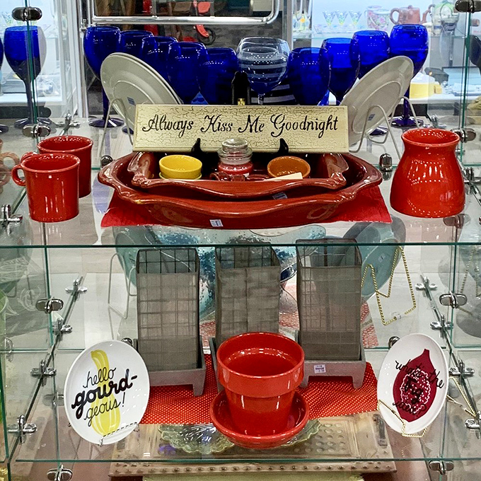 Cobalt blue glassware and cheery red pottery &ndash; someone's dining table is about to get a colorful upgrade. That "Kiss Me Goodnight" sign seals the deal.