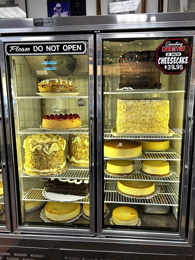 The dessert case stands as a museum of magnificent cheesecakes and towering layer cakes that would make a cardiologist both weep and salivate.