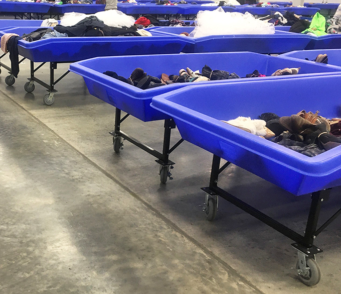 The blue bins stretch into the distance like an ocean of possibilities. Each one a floating island of potential discoveries.