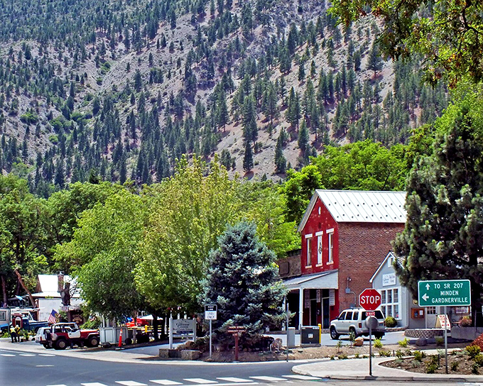 The intersection of history and everyday life, where colorful buildings pop against the dramatic mountain backdrop that defines Genoa's character.