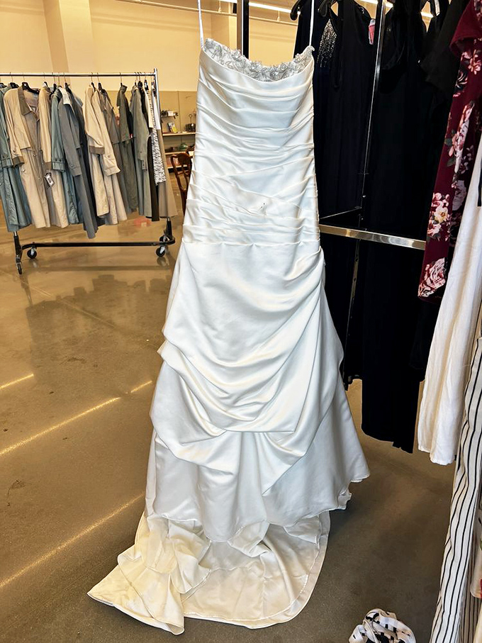 Someone's forgotten wedding dress becomes another bride's budget-saving miracle. This elegant gown represents the beautiful serendipity that makes thrift shopping so magical.