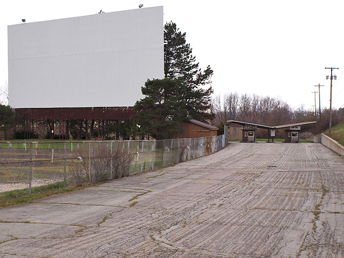 In daylight, the massive screen waits patiently, like a storyteller gathering energy before spinning tales after sunset.