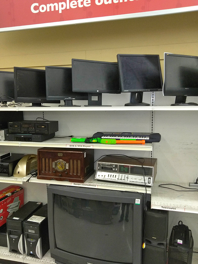 Technology time capsules line these shelves, from vintage stereos to computer monitors that witnessed the dawn of the internet.