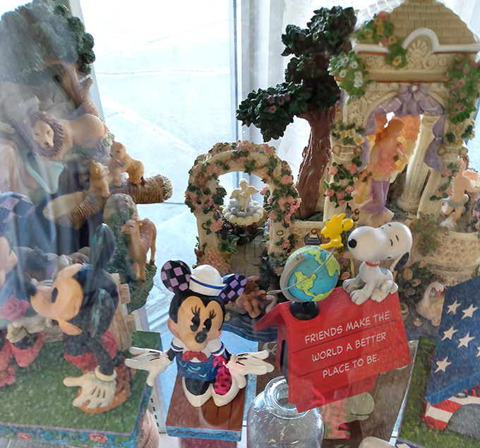 Collectible figurines behind glass&mdash;Snoopy and Minnie remind us that friends do indeed make the world a better place to be.