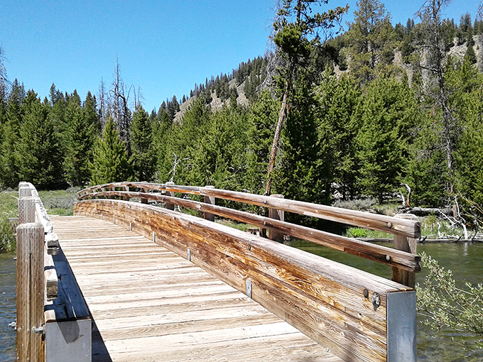 Crossing this footbridge feels like stepping into a Robert Frost poem&mdash;the wooden path less traveled by makes all the difference.