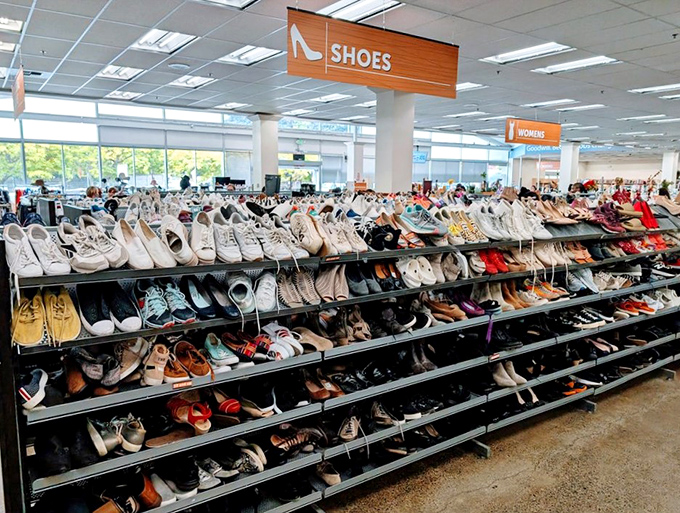 The shoe section—a footwear anthropologist's dream where barely-worn hiking boots neighbor with vintage heels from dance floors past.