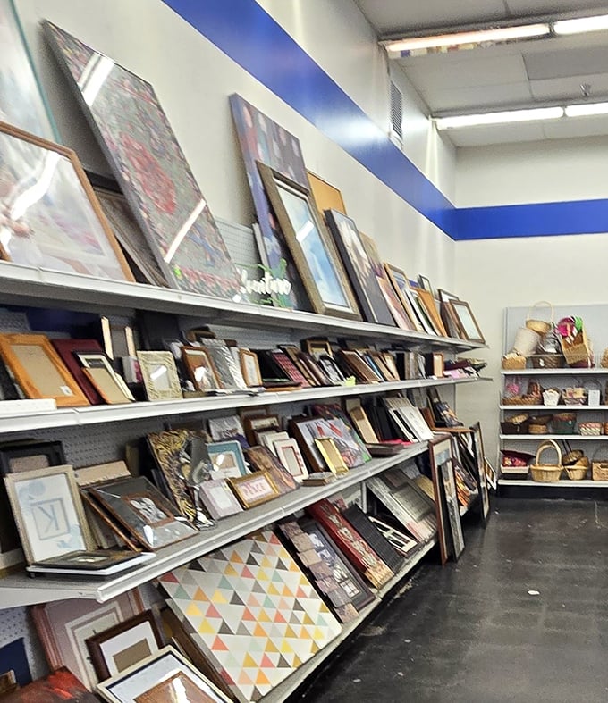 Frame-tastic! This wall of potential holds everything from basic black to ornate gold, waiting to embrace your family photos or thrift store art finds.