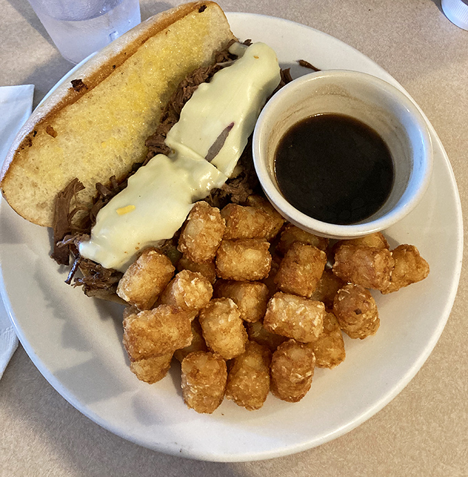 The French Dip comes loaded with tender beef and golden tater tots, plus au jus for proper dunking.