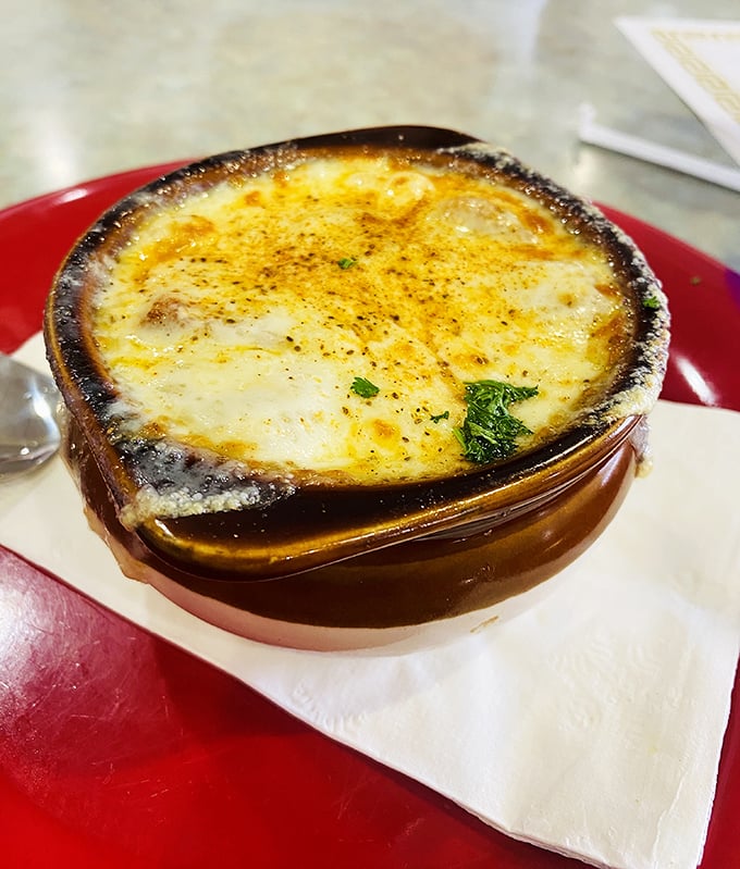 French onion soup with a cheese roof so perfect it deserves its own architectural award. Breaking through that top layer is pure therapy.