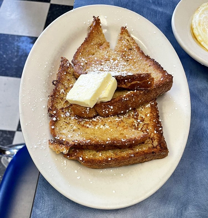 French toast that's crisp-edged and tender-centered, dusted with powdered sugar and topped with butter &ndash; the breakfast equivalent of a warm hug.
