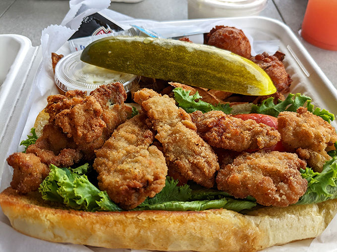 That fried oyster po' boy is piled so high with golden goodness it practically needs its own zip code and possibly structural support beams.