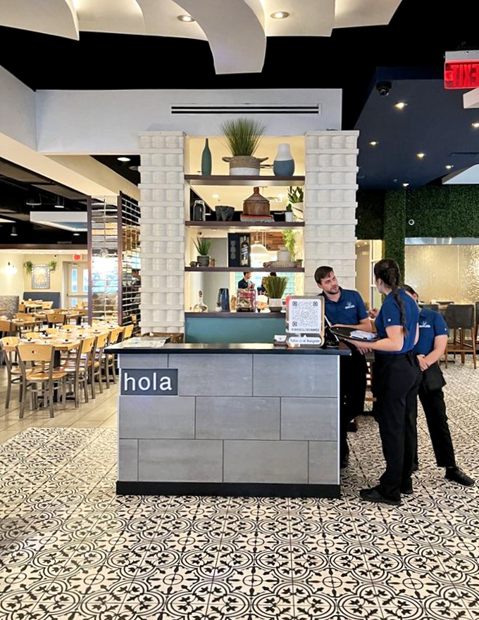 "Hola" says it all at this welcoming host stand, where the patterned tile floor and modern design elements set the tone for your Mexican feast.