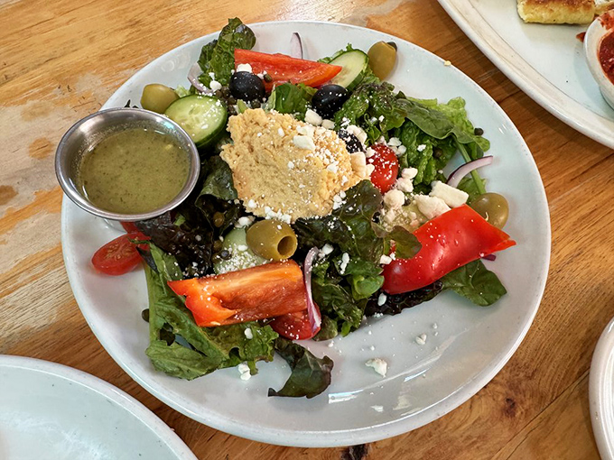 A Greek salad that actually tastes like something&mdash;crisp vegetables, briny olives, and a generous crumble of feta with house-made dressing.