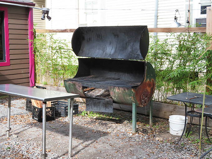 That weathered smoker has seen things, done things. It's the wise elder of the backyard, imparting smoky wisdom to everything it touches.