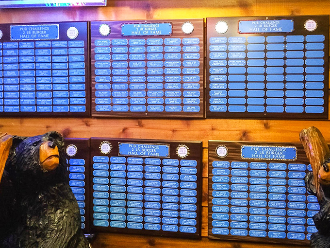 The Hall of Fame wall &ndash; where food warriors are immortalized. Each plaque represents someone who looked a monster burger in the eye and didn't blink.