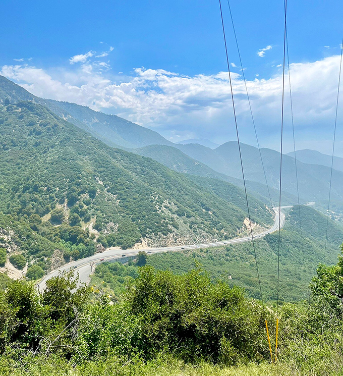 Morning mist transforms mountains into mysterious blue ghosts. This ethereal landscape looks like it was painted with watercolors by a master artist.