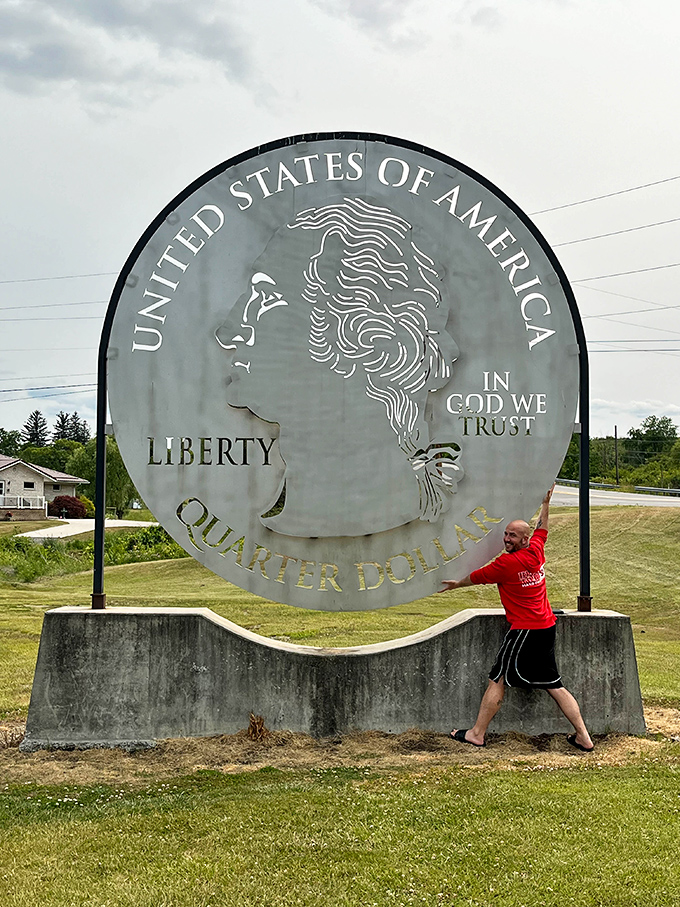 "I'm trying to lift it, but it won't budge!" The Giant Quarter inspires playful interactions that make for memorable travel moments.