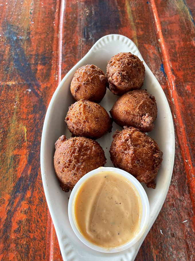 Hush puppies that speak volumes&mdash;golden-brown spheres of cornmeal perfection with a soft, fluffy interior worth breaking the silence for.