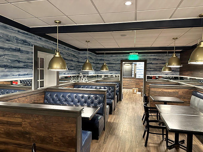 Navy blue booths and weathered wood create the perfect maritime backdrop for seafood feasts, like dining in the captain's quarters of a particularly delicious ship.