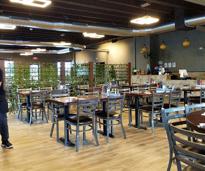 Greenery and modern lighting transform a simple space into somewhere special. The plant wall creates a garden-like atmosphere that enhances every bite.