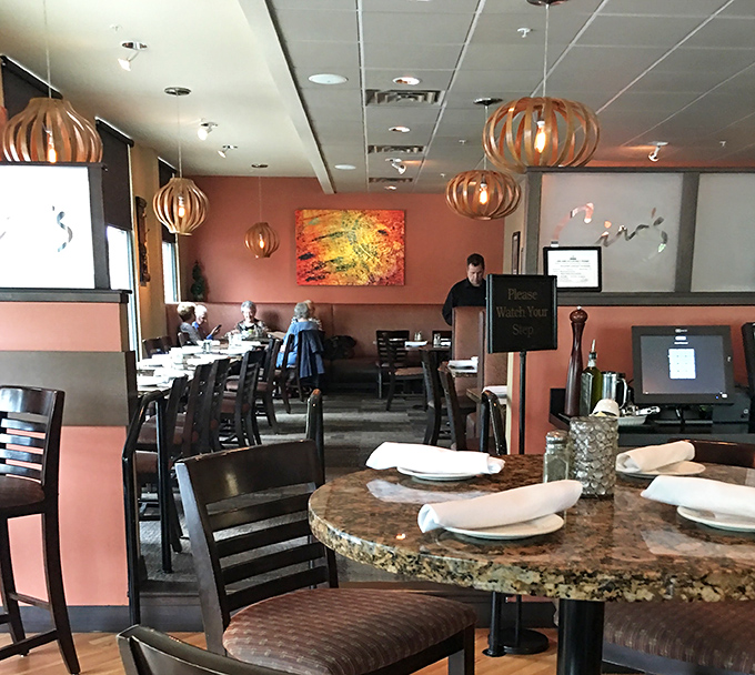 Wooden pendant lights cast a warm glow over granite tables, creating that "I've discovered something special" feeling that makes regulars out of first-timers.