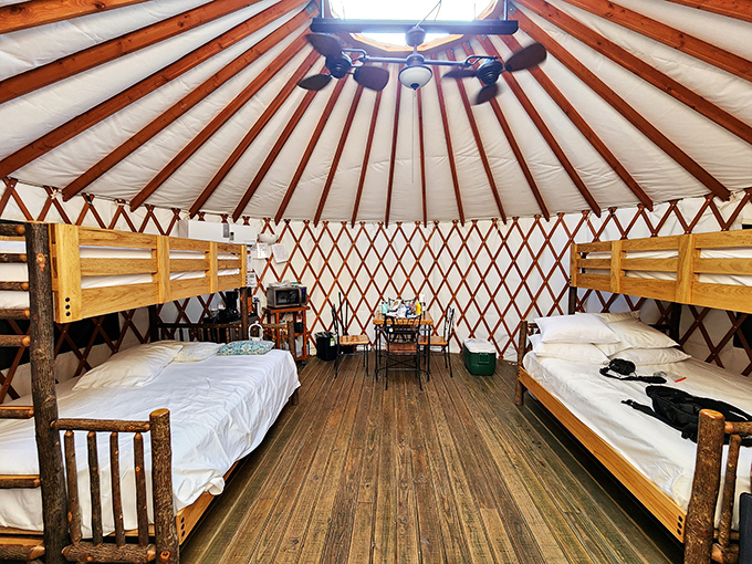 Inside the yurt, rustic meets comfort with wooden bunks and actual beds &ndash; proving that sleeping under the stars doesn't require sleeping on them.