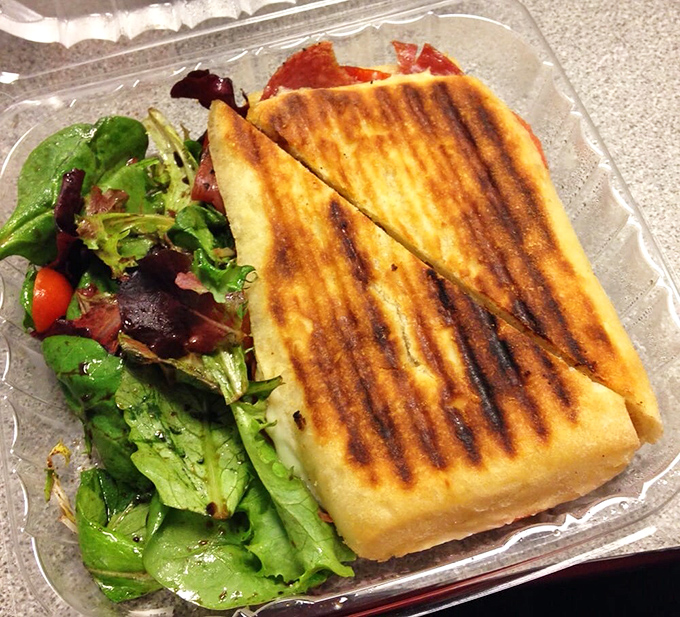 A panini that doesn't need to shout to be heard, paired with greens that didn't come from a plastic bag. Lunch, elevated.