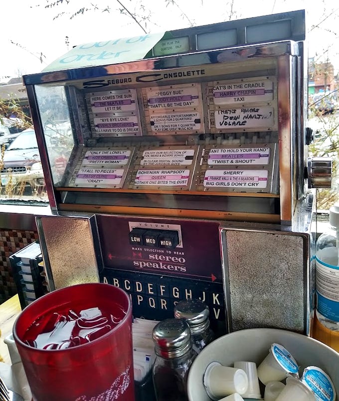 The vintage jukebox stands as a time machine, ready to transport diners back to simpler times with the press of a button.