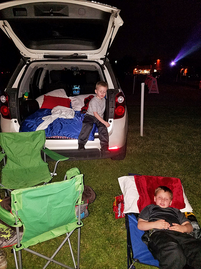 Family movie night done right! These kids have the ultimate setup&mdash;blankets, snacks, and the back of an SUV transformed into comfort central.