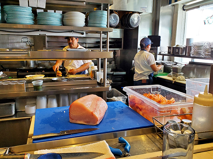 Behind the scenes, fresh fish awaits its transformation into something extraordinary by skilled hands and sharp knives.