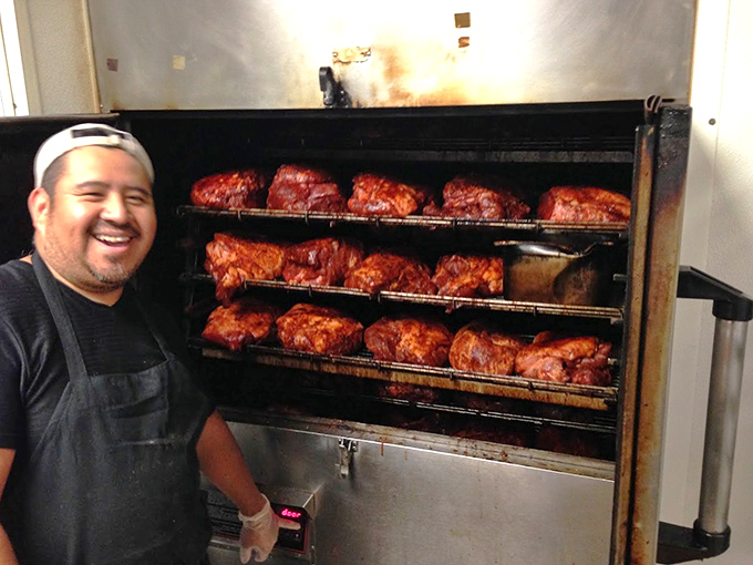 Behind the scenes where the magic happens. Those racks of meat are like a smoky art gallery where patience transforms raw ingredients into masterpieces.