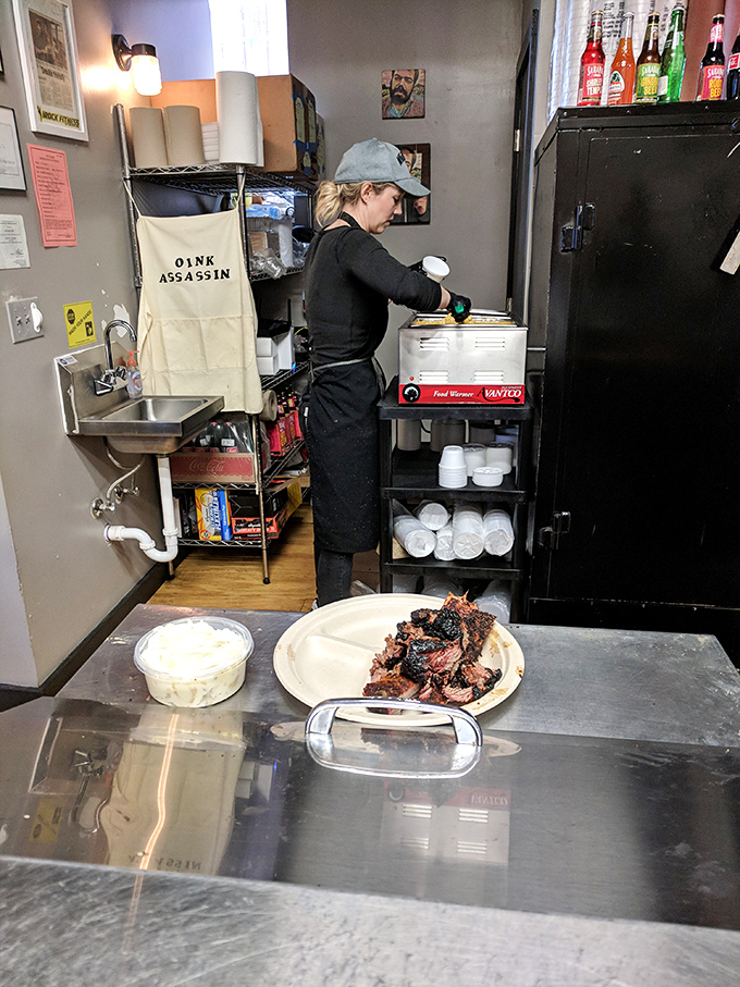 The kitchen ballet unfolds with practiced precision. Every movement matters when you're serving food this good to hungry crowds.
