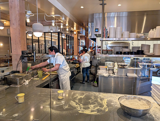 Watch skilled hands transform simple ingredients into dinner magic while you wait, which beats scrolling through your phone endlessly.