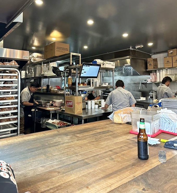 Behind the scenes where smoke meets science: the kitchen crew orchestrates meat magic with precision and purpose.