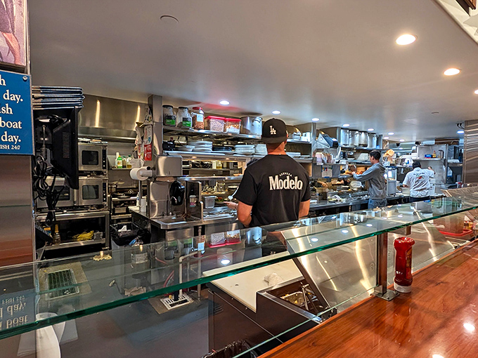 The open kitchen reveals the choreography behind your meal. Watching chefs work is like seeing the backstage of a Broadway show, but with better snacks.