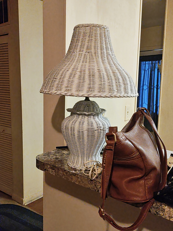 Wicker lamp and vintage leather purse&mdash;a still life of coastal Florida elegance that whispers "come in, kick off your shoes, stay awhile."