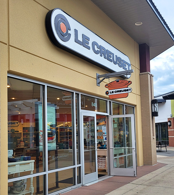 Le Creuset's colorful cookware gleams like jewels behind glass, tempting home chefs to elevate their kitchen game without emptying their wallets.