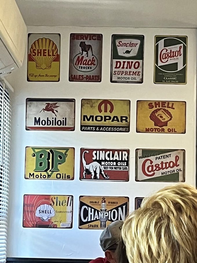 Vintage oil and automotive signs create a nostalgic backdrop, transforming a meal into a journey through America's roadside past.