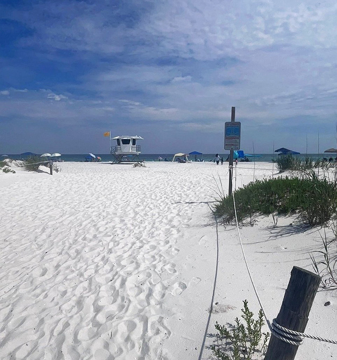 Lifeguard on duty, though the gentle waters rarely demand heroics. The tower stands as a reassuring landmark on this stretch of paradise.